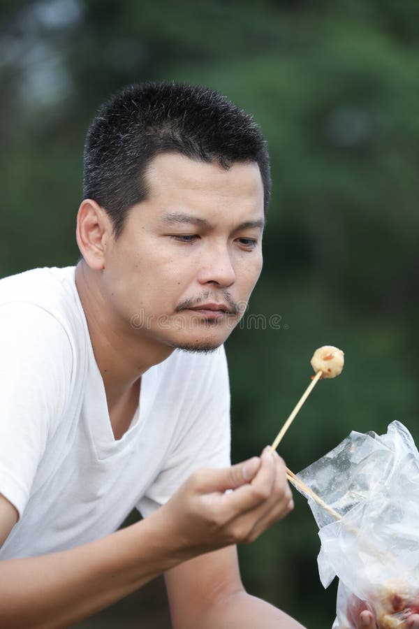A man eating meatball stock image. Image of looking, person - 72434295