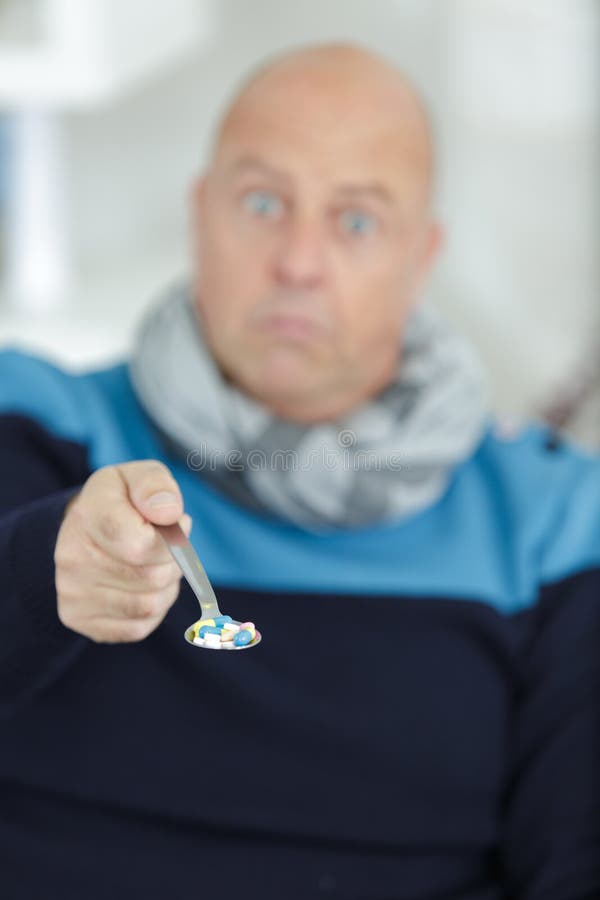 Man Eating Pills with Spoon Stock Image - Image of dose, medical: 174510591