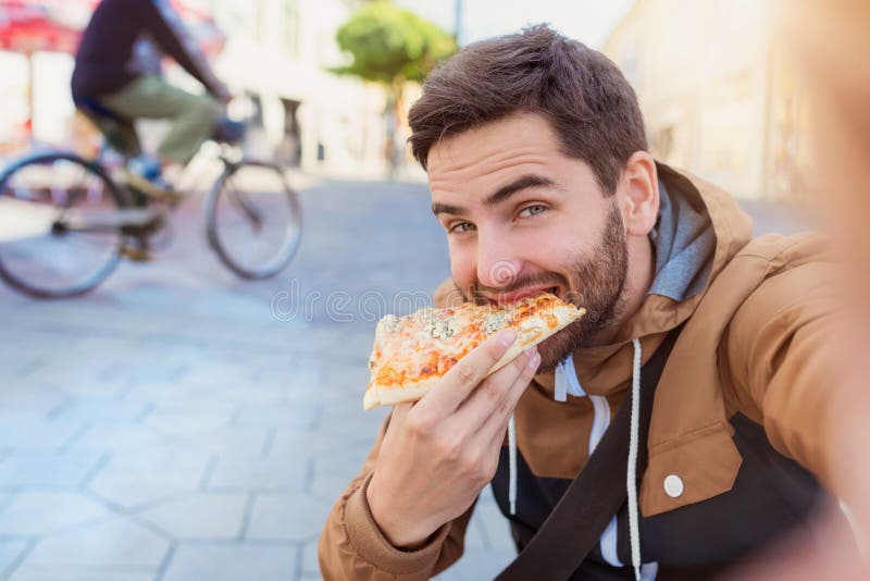 Man eating pizza stock photo. Image of adult, holding - 60724120