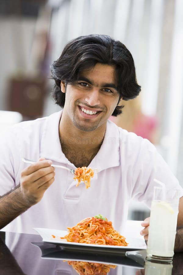 Man Eating Plate of Pasta at Cafe Stock Photo - Image of snack, camera ...