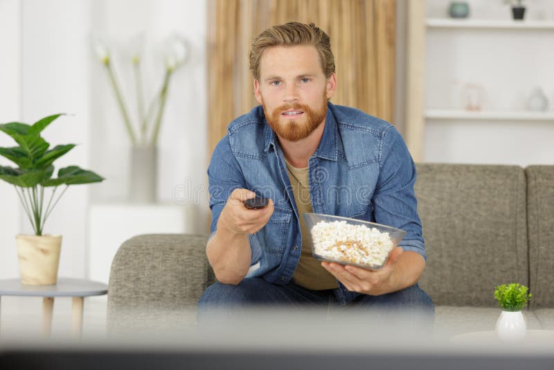 Man Eating Popcorn on Sofa - Studio Shoot Stock Photo - Image of 2030 ...