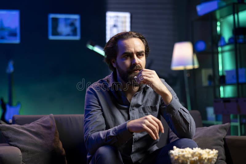 Man Eating Popcorn while Watching Interesting Movie Stock Image - Image ...