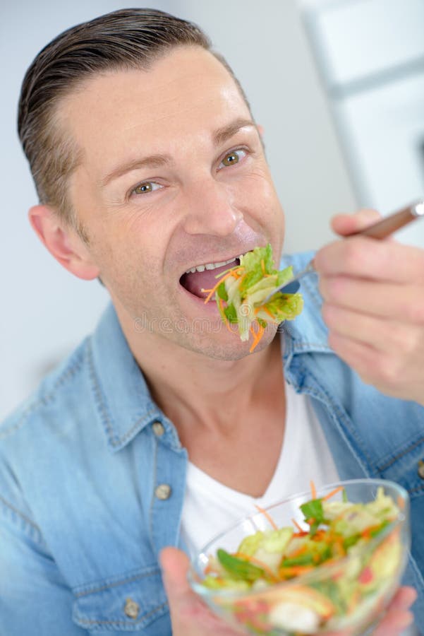 Man eating salad stock photo. Image of isolated, lunch - 253358332 Man eating salad stock photo. Image of isolated, lunch - 253358332