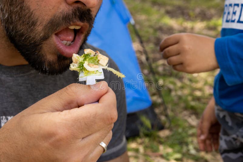 Man Eating Salad in Plastic Container in the Field Stock Image - Image ...