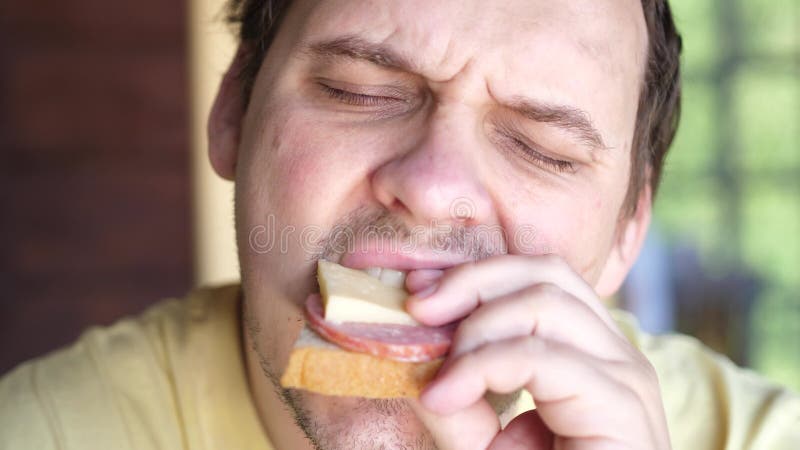 Man Eating Sandwich with Cheese and Sausage. Close Up Stock Video ...