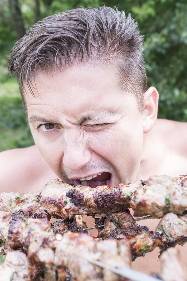Man is eating shish kebab stock photo. Image of forest - 122745700