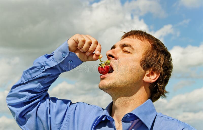 Man eating strawberry. stock photo. Image of open, healthy - 25335372