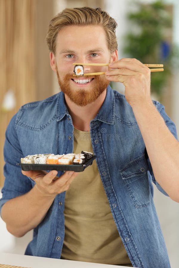 Man eating sushi stock photo. Image of cafe, ingredient - 278505854