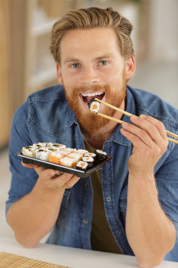 Man Eating Sushi with Chopstic Stock Photo - Image of dish, slice ...