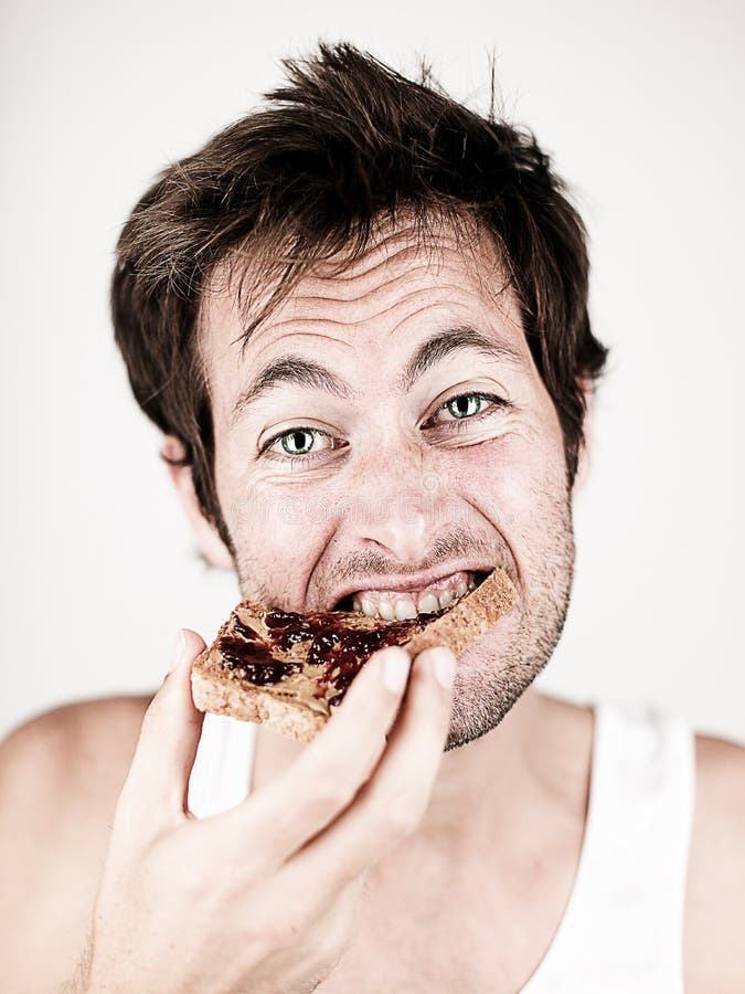 Man Eating Toast with Peanut Butter and Jelly Stock Photo - Image of ...