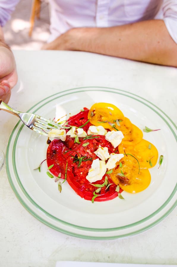 Man Eating Tomato Salad and Cheese Stock Photo - Image of tomato ...