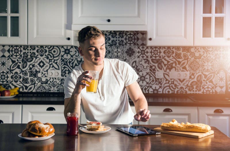 Man Eating and Using Tablet Stock Photo - Image of sunrise, drink ...