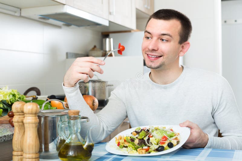 Man Eating Vegetable Salad in Kitchen Stock Image - Image of meal ...