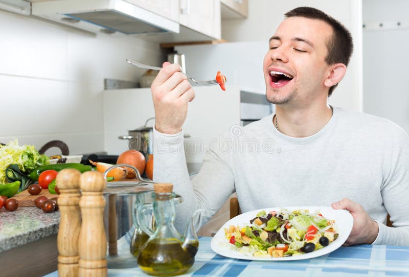 Man Eating Vegetable Salad in Kitchen. Stock Photo - Image of pepper ...