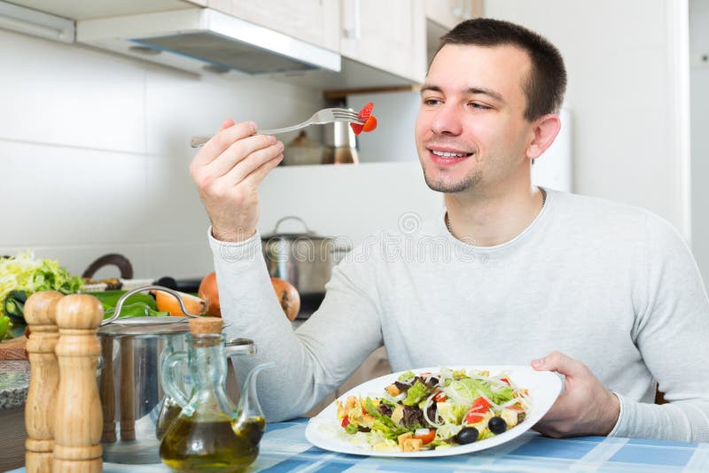Man Eating Vegetable Salad in Kitchen Stock Image - Image of fork ...