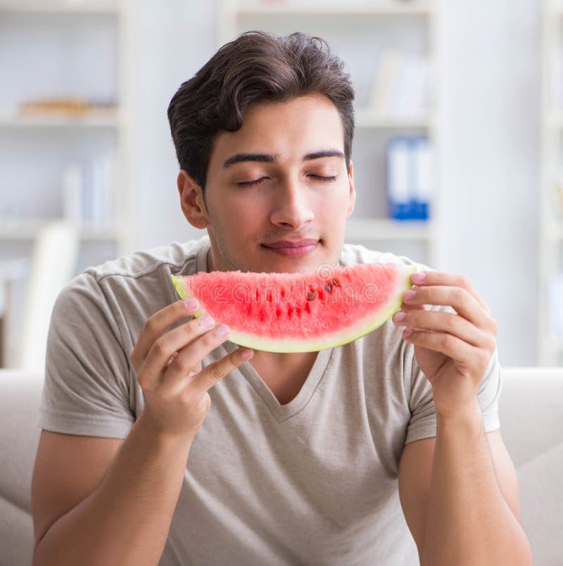 Man Eating Watermelon at Home Stock Photo - Image of handsome ...