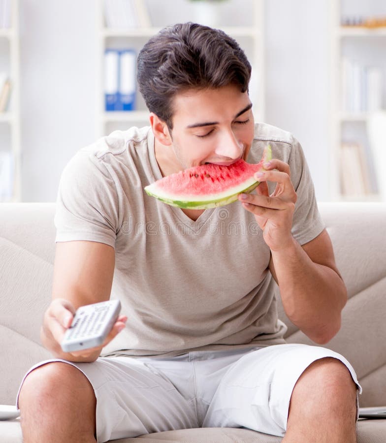Man Eating Watermelon at Home Stock Image - Image of football ...