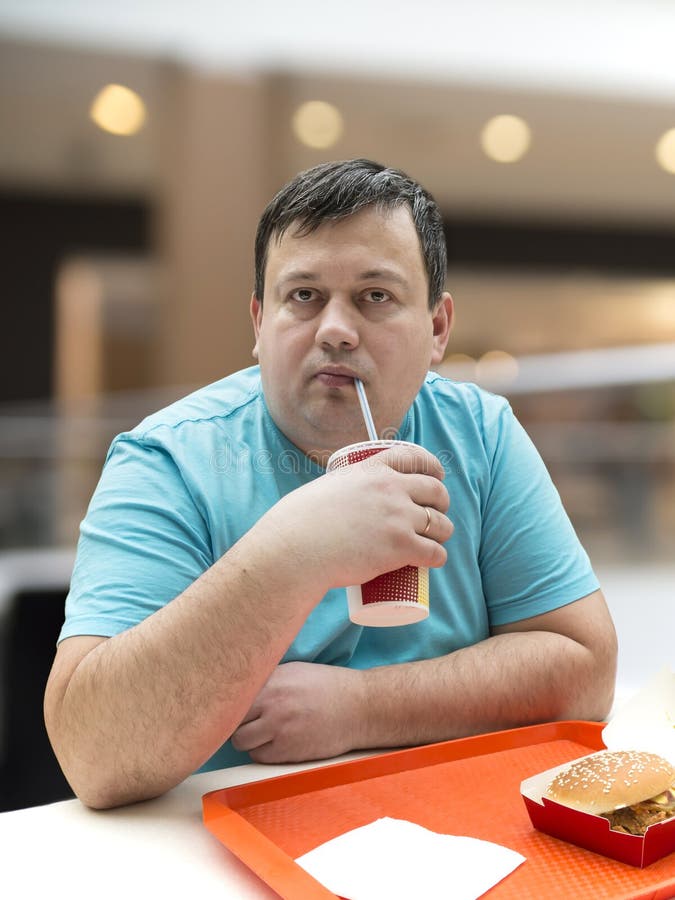The man eats fast food stock image. Image of hair, burger - 67972673