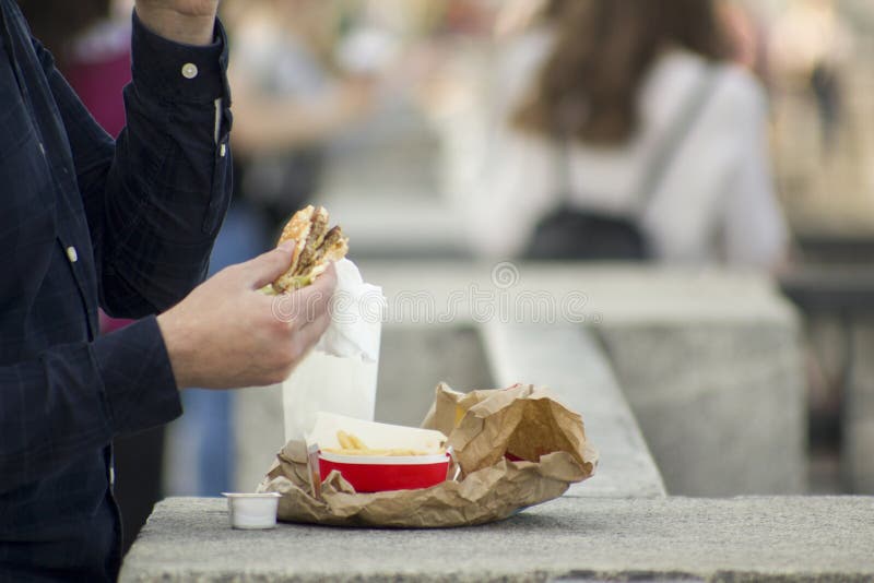 The Man Eats a Fast Food on the Street Stock Photo - Image of diner ...