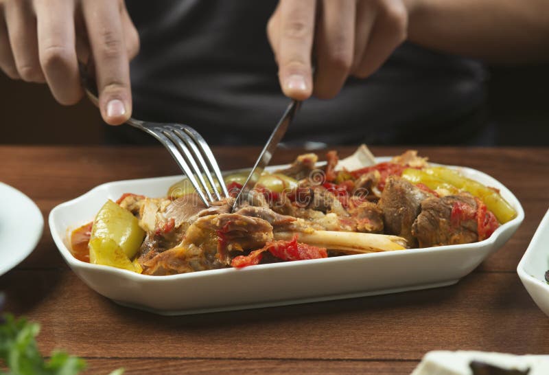 Man Eats Lamb Stew on the Bone with Vegetables Stock Photo - Image of ...