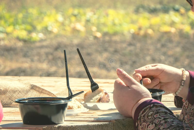 A Man Eats from Plastic Plates in an Open Space Stock Photo - Image of ...