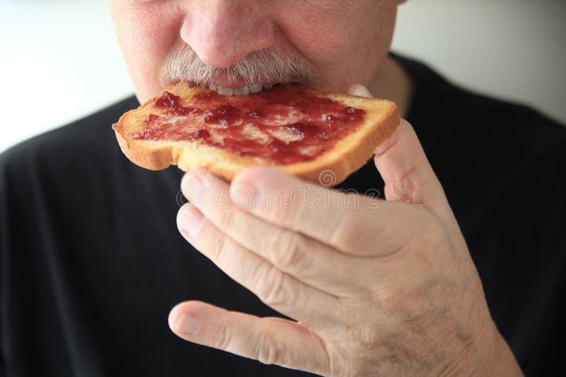 Man Eats Slice of Toast with Jam Stock Photo - Image of textures, face ...