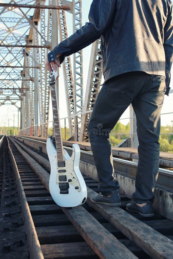 Man with an Electric Guitar in the Industrial Landscape Outdoors Stock ...
