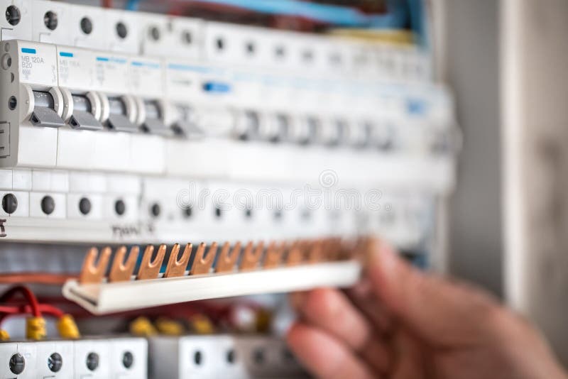 Man, an Electrical Technician Working in a Switchboard with Fuses ...