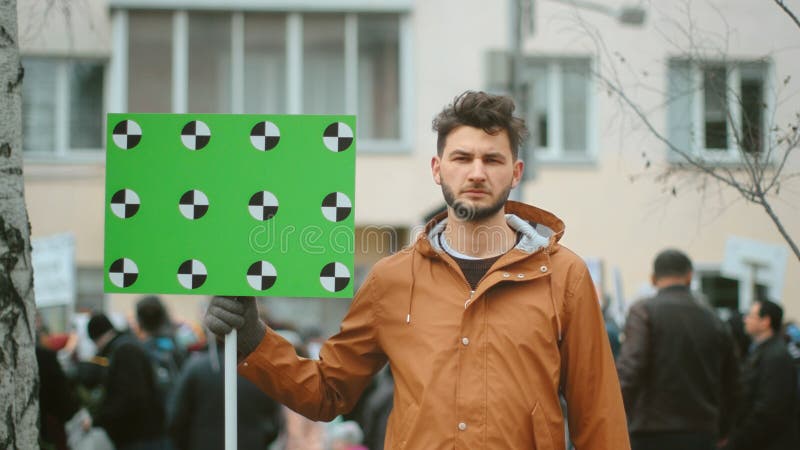 Man with Empty Green Banner with Tracking Points. Custom Message. Copy ...