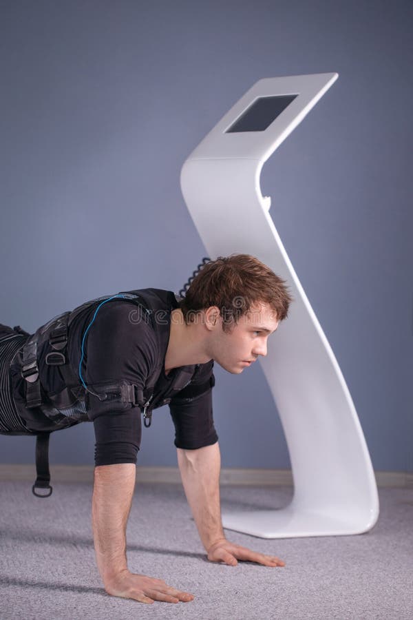 Man in Electrical Muscular Stimulation Suits Doing Plank Exercise. EMS ...