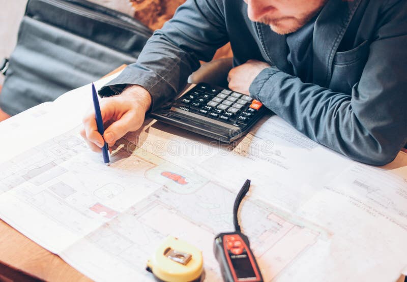 Man Engineer Designer Architect Reading Drawings at Table in Cafe Stock ...