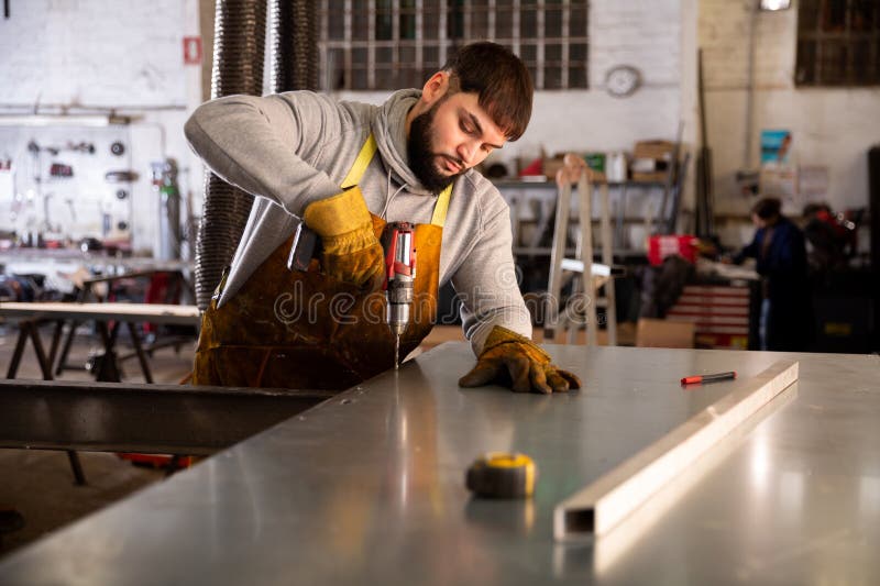 Man Engineer Drilling Metal Sheet in Workshop Stock Photo - Image of ...