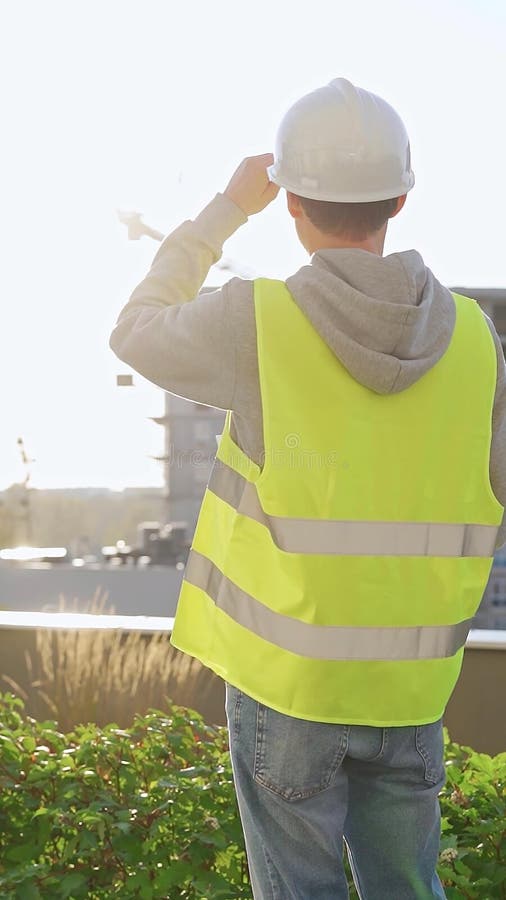 Man Engineer with White Helmet and Safety Vest is Using Tablet Computer ...