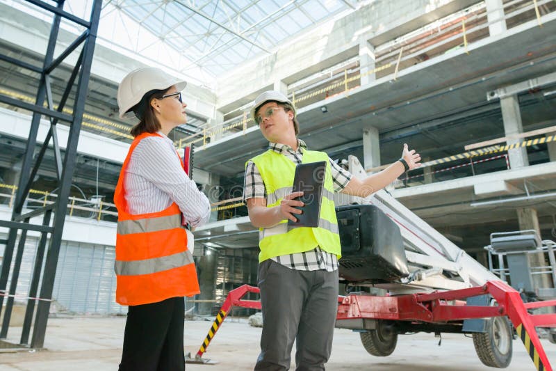 Man Engineer and Woman Architect at a Construction Site. Building ...