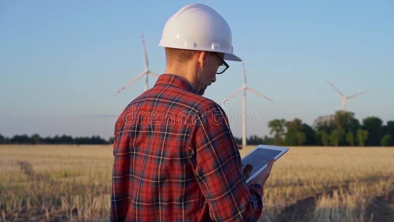 Man Engineer at Work is Taking Notes with a Tablet Computer in a Field ...