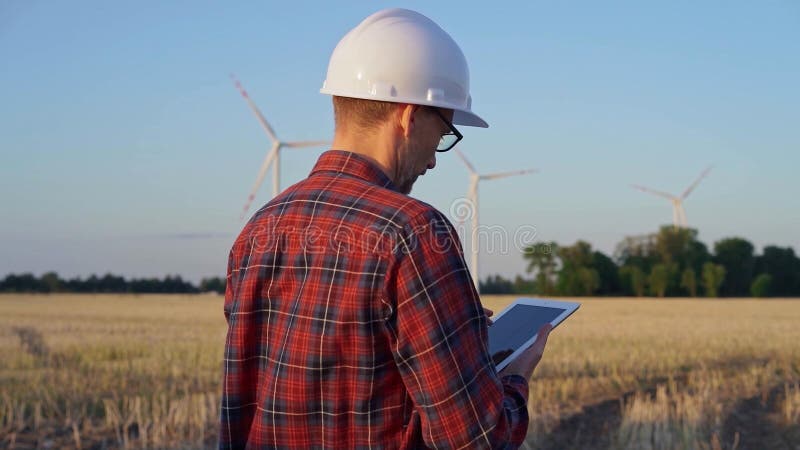 Man Engineer at Work is Taking Notes with a Tablet Computer in a Field ...