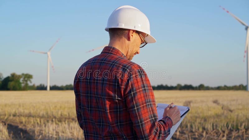 Man Engineer at Work is Wearing a White Protective Helmet and Taking ...