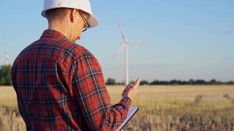 Man Engineer at Work is Wearing a White Protective Helmet and Taking ...