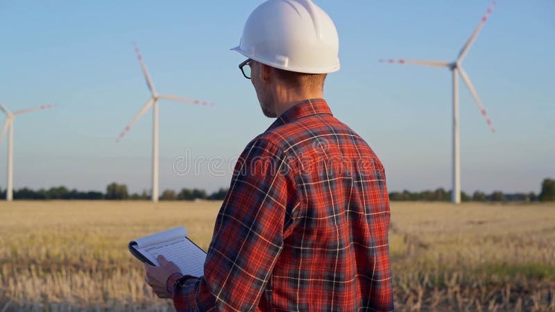 Man Engineer at Work is Wearing a White Protective Helmet and Taking ...