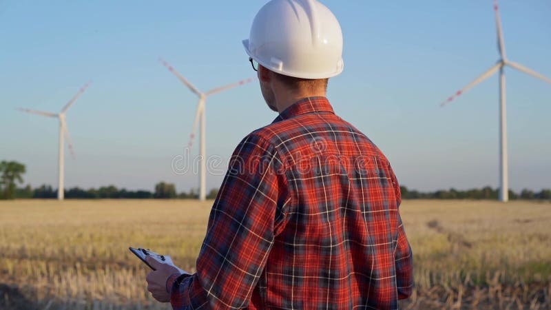 Man Engineer at Work is Wearing a White Protective Helmet and Taking ...