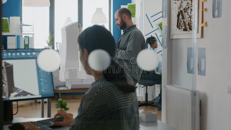 Man Engineer Working with Building Model and Blueprints To Plan Urban ...