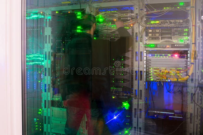 The Man Engineer Works in the Server Room of a Modern Data Center ...