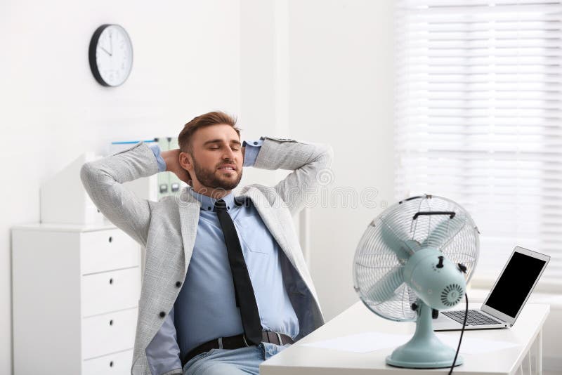 Man Enjoying Air Flow from Fan at Workplace Stock Image - Image of ...