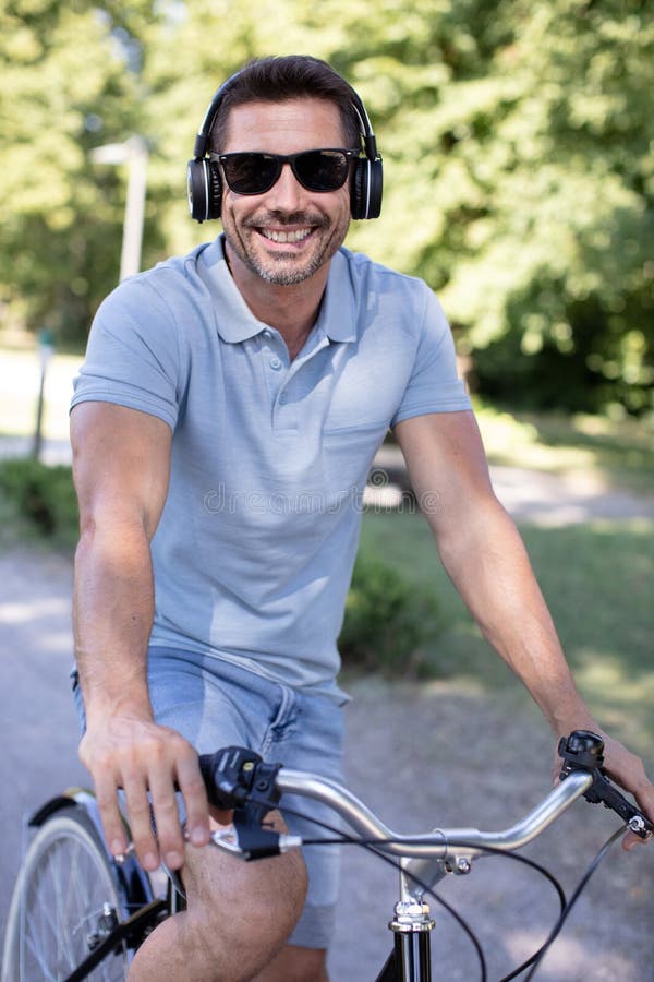 Man Enjoying Music Using Earphones while Commuting on Bicycle Stock ...