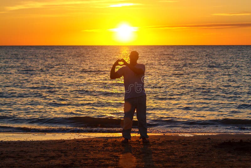 A Man Enjoys Life on the Beach at Sunset Stock Image - Image of evening ...