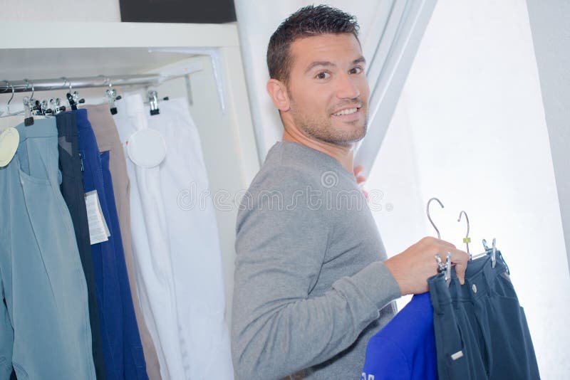 Man Entering Changing Room with Selection Clothes Stock Image - Image ...