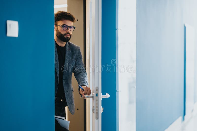 Man Entering a Modern Blue-painted Office Space with Confidence Stock ...