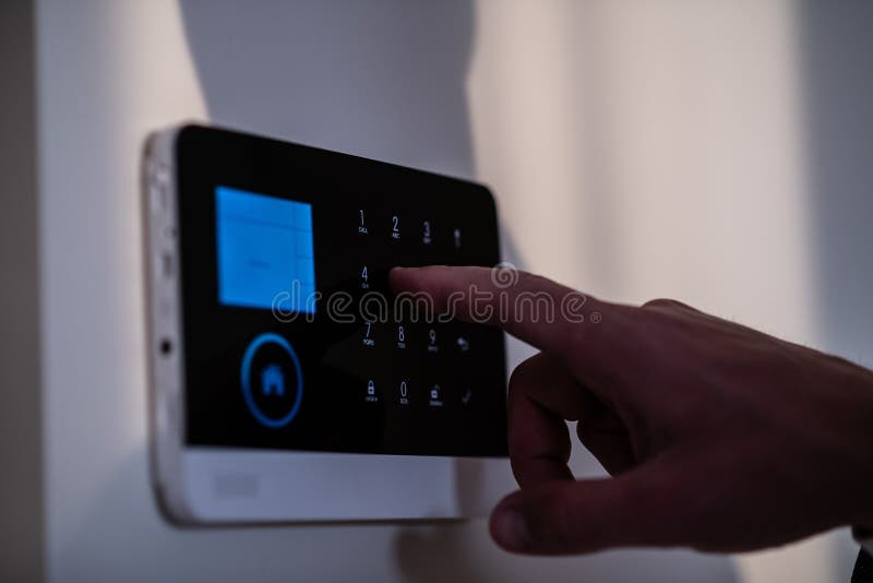 Man Enters the Code into the Alarm Using the Alarm System& X27;s Keypad ...