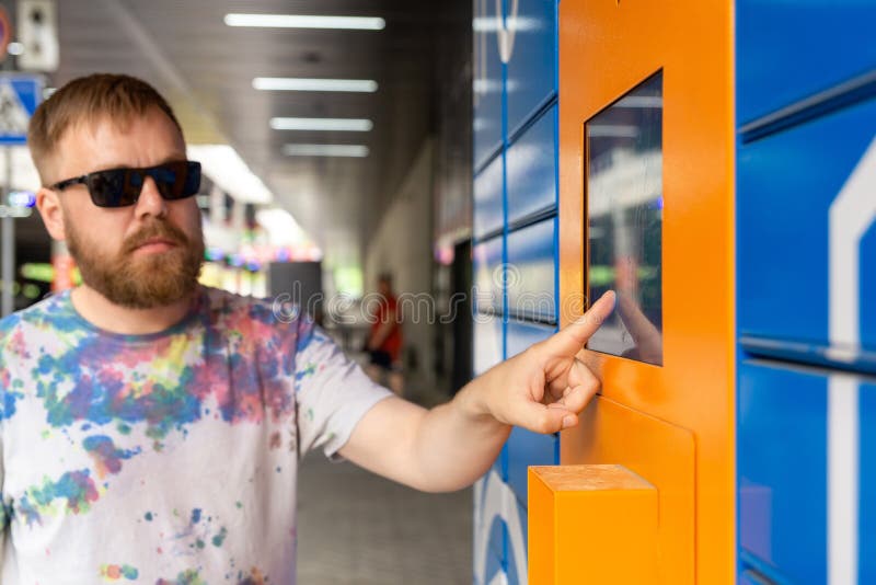 Man Enters Parcel Code on Screen and Picks Up Parcel from Automated ...