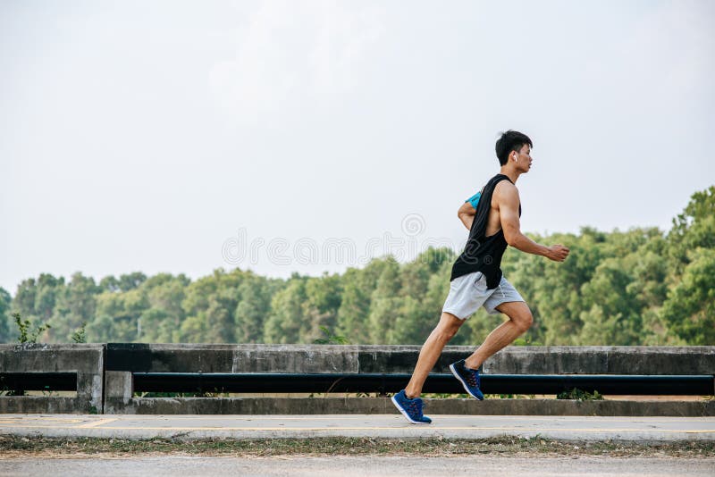 Men Exercise by Running on the Road on the Bridge Stock Image - Image ...